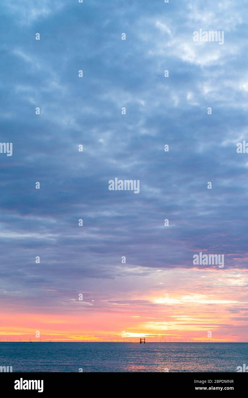 The dawn sky over the Thanet offshore wind farm off the Kent coast in ...