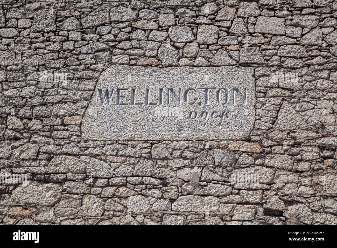 Sign on the old stone wall of the Wellington Dock, part of the Port of ...