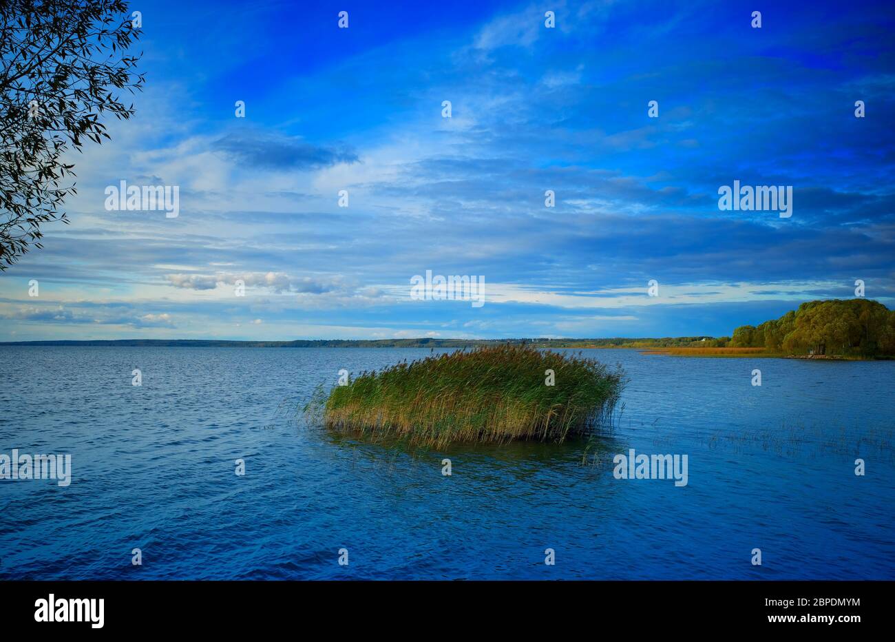 Dramatic spike island on river landscape background Stock Photo - Alamy