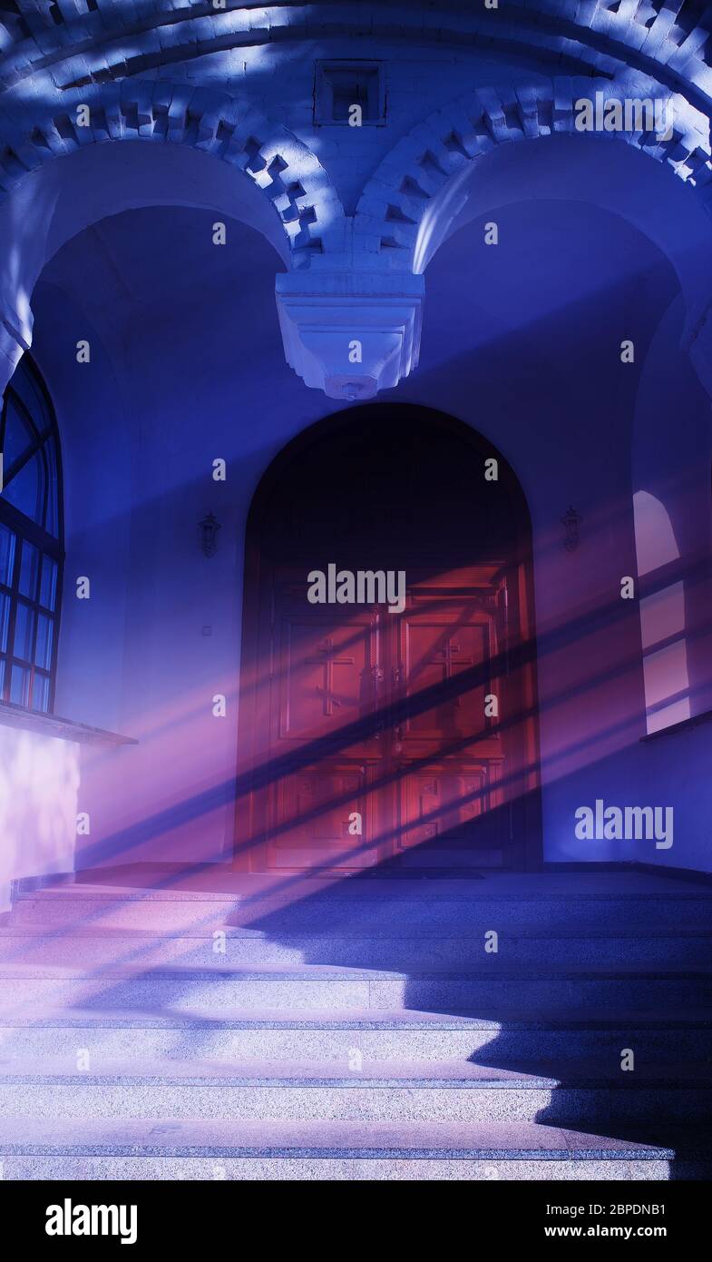Dramatic light rays illuminating church entrance background Stock Photo ...