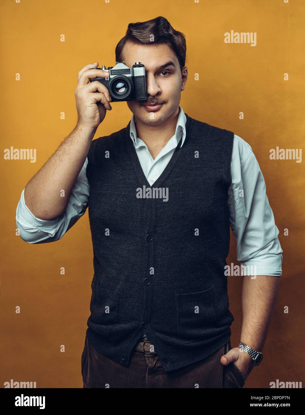 Man holding film camera hi-res stock photography and images - Alamy