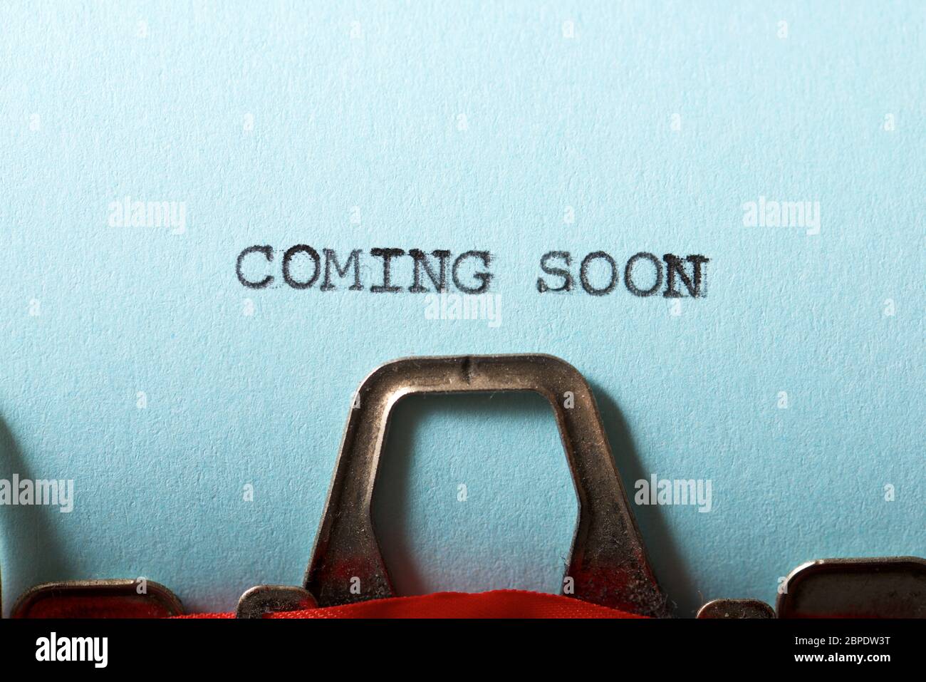 Coming soon text written on a paper Stock Photo - Alamy