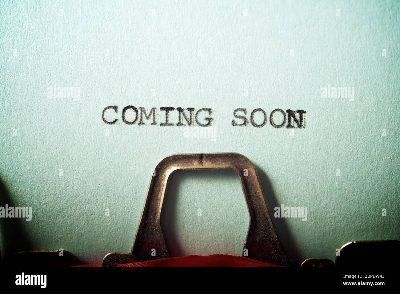 Coming soon text written on a paper Stock Photo - Alamy