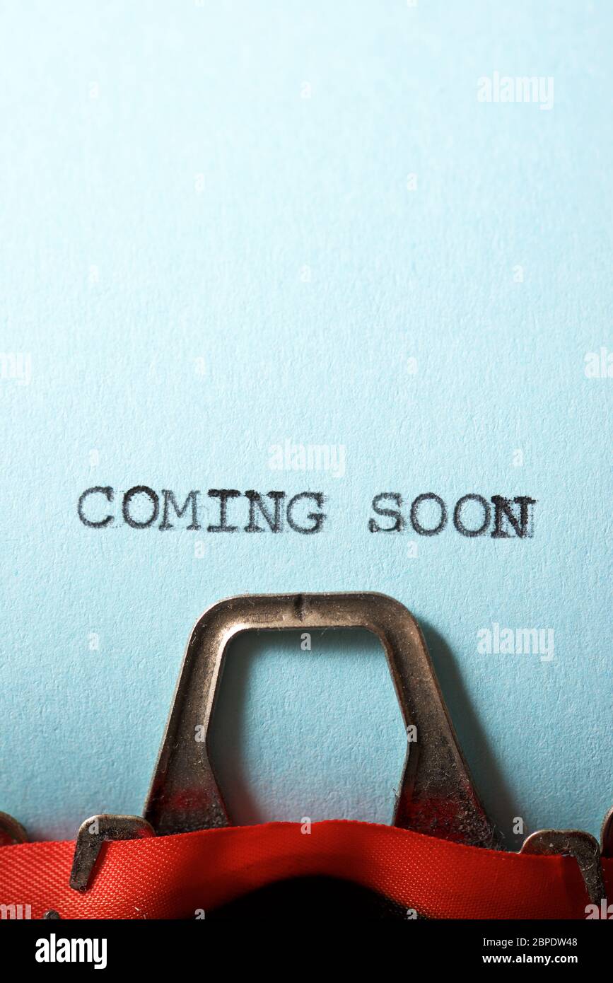 Coming soon text written on a paper Stock Photo - Alamy