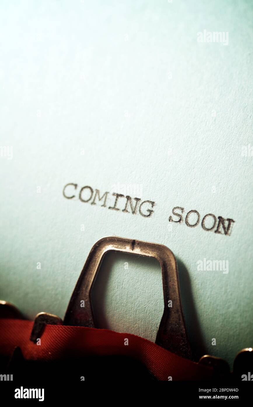 Coming soon text written on a paper Stock Photo - Alamy