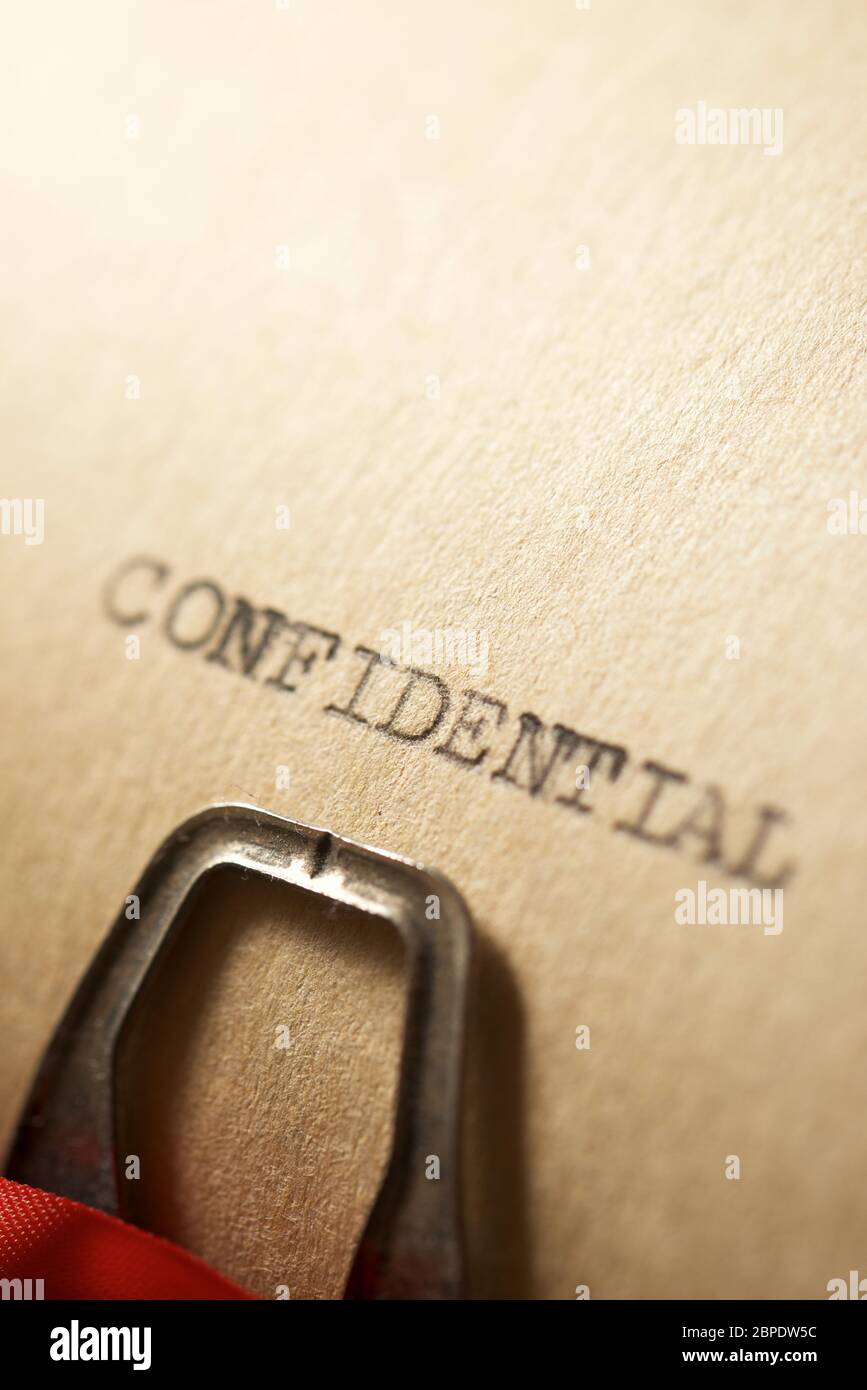 Confidential word written on a paper Stock Photo - Alamy