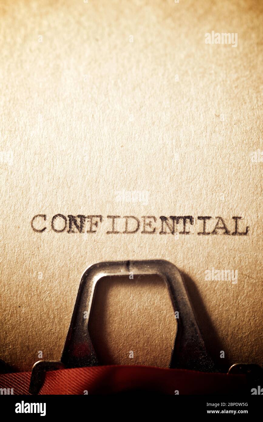 Confidential word written on a paper Stock Photo - Alamy
