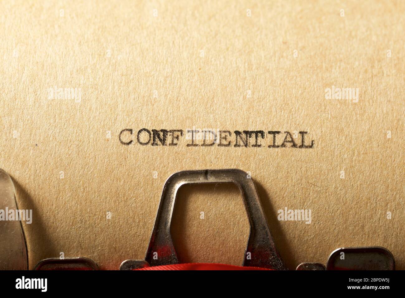 Confidential word written on a paper Stock Photo - Alamy