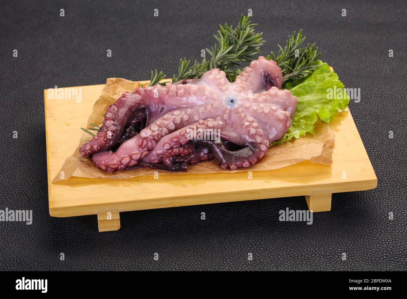 Raw octopus ready for cooking with rosemary Stock Photo - Alamy