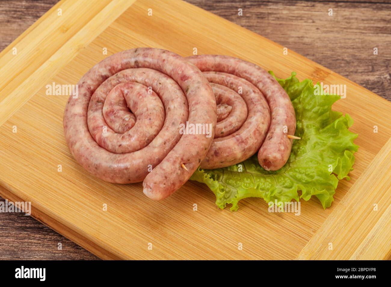Raw pork sausage ring for grill Stock Photo - Alamy