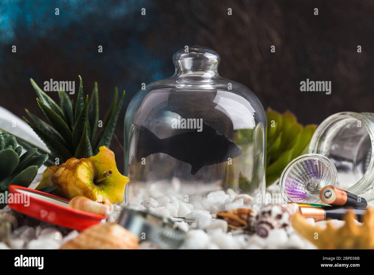 silhouette of fish under glass jar in polluted sea creative concept ...