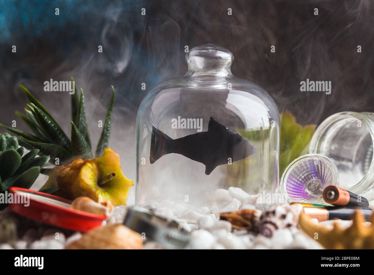 silhouette of fish under glass jar in polluted sea creative concept ...