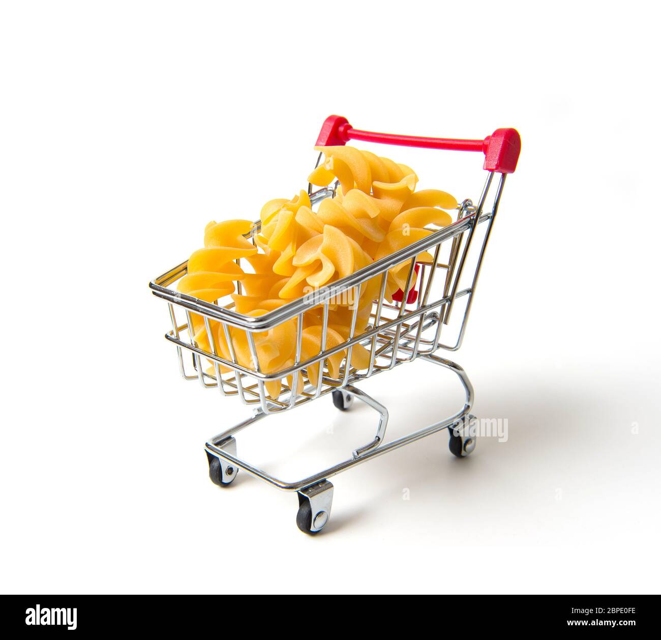 Supermarket shopping trolley on a white background filled with fusilli ...