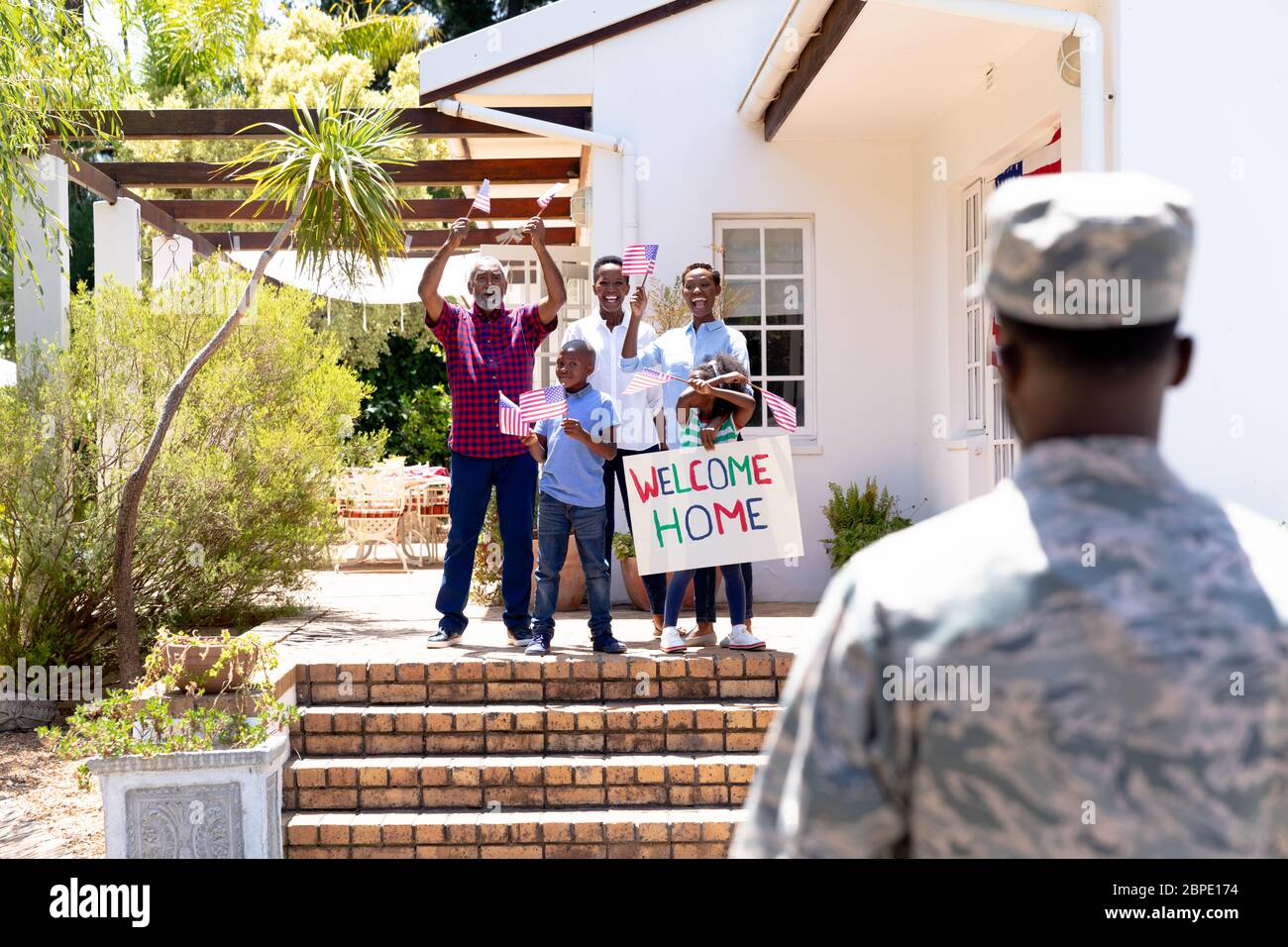 African American male soldier wearing uniform and his family standing ...