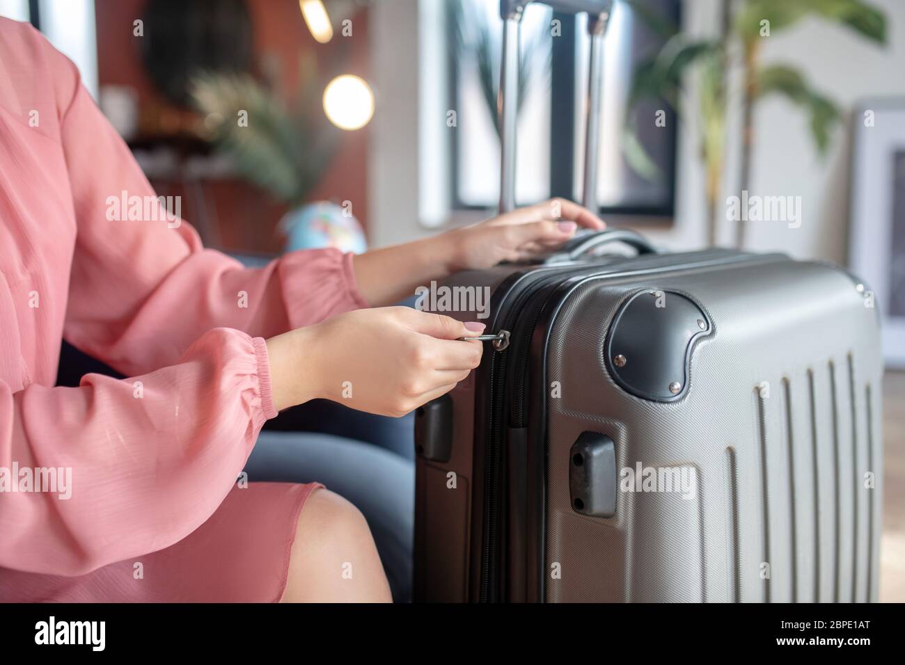 Close-up of female hands zipping her suitcase Stock Photo - Alamy