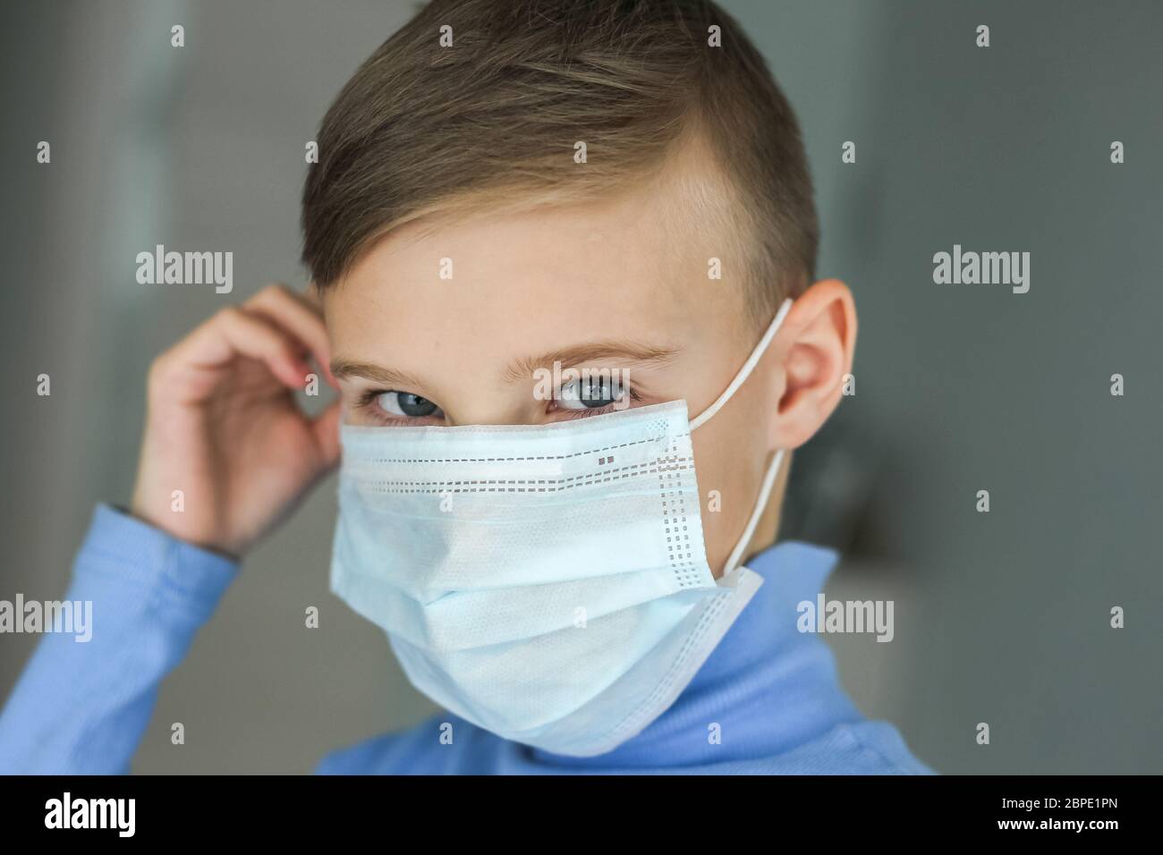 Kid puts mask on hi-res stock photography and images - Alamy