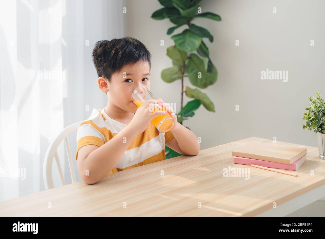 Little boy drinking orange juice hi-res stock photography and images ...