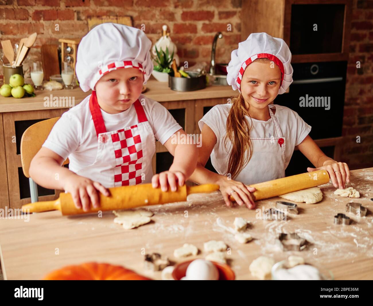 Children enjoying cooking in the kitchen. Boy and Girl at the kitchen ...