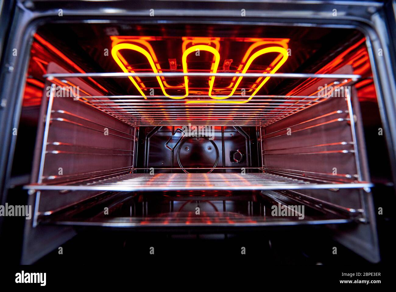 Empty hot oven with a flaming grill close-up Stock Photo - Alamy