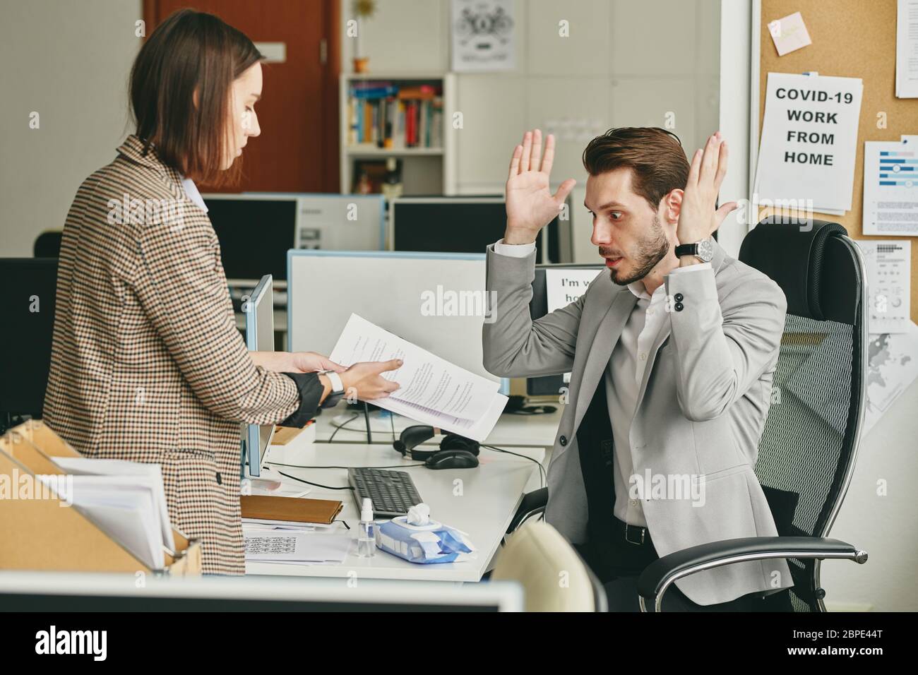 Assistant showing contract to manager and explaining contractual ...