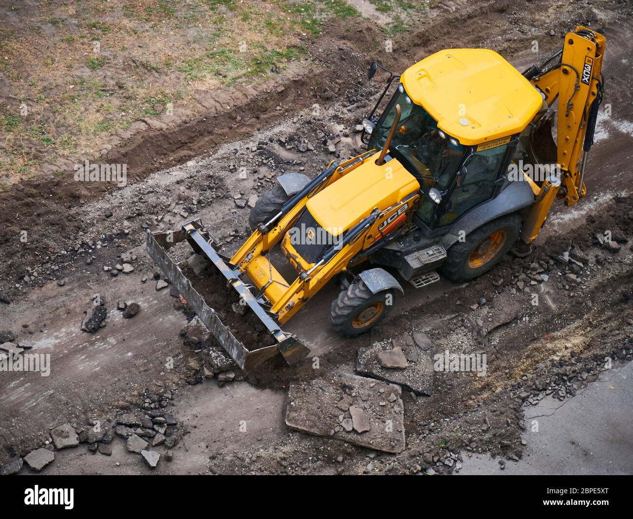 Hydraulic Excavator Removing Remains of asphalt. Road reconstruction ...