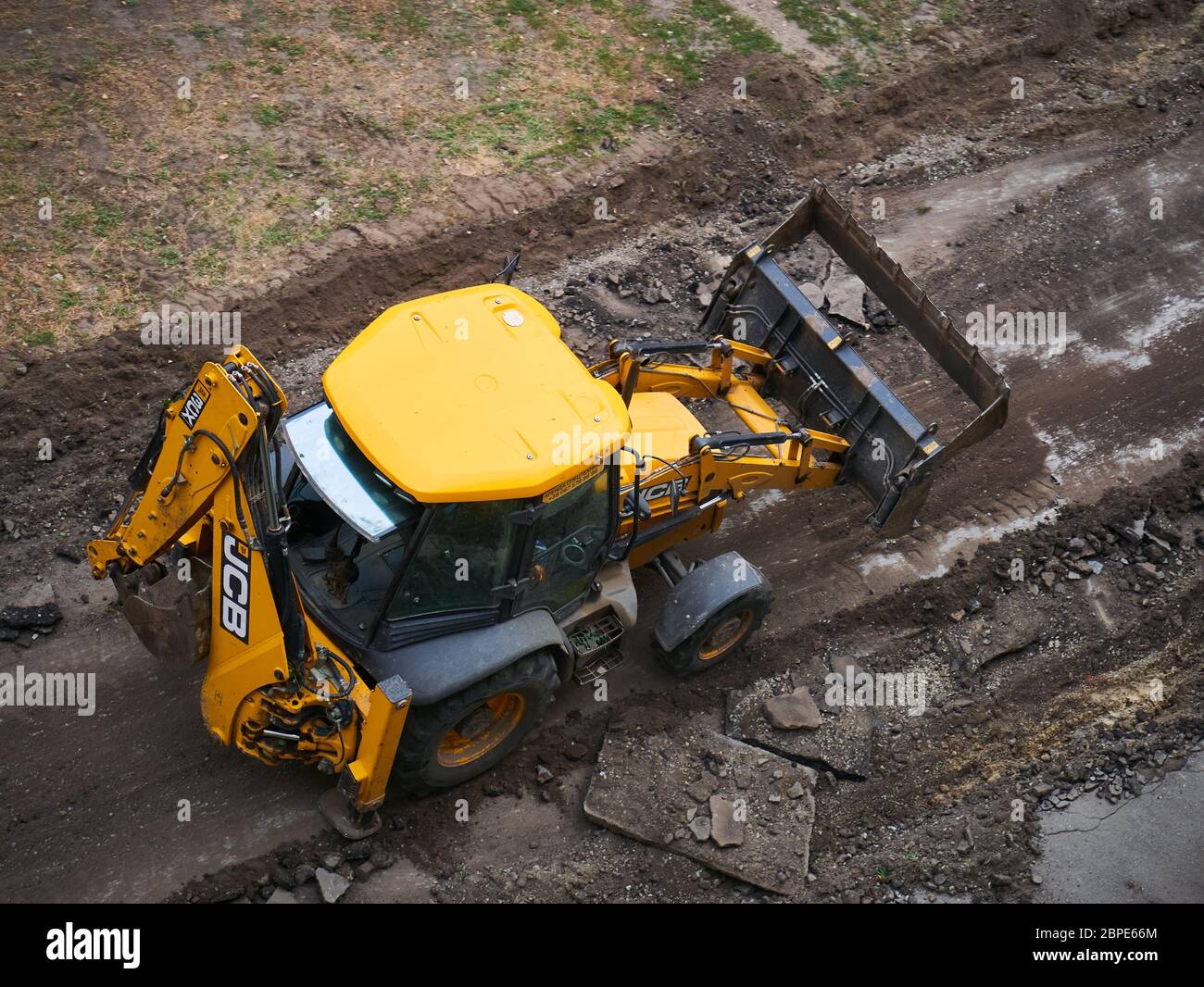 Hydraulic Excavator Removing Remains of asphalt. Road reconstruction ...