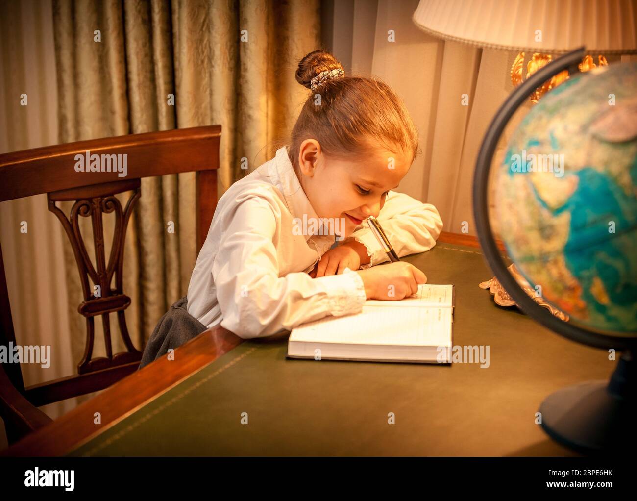 Little girl doing geography homework Stock Photo - Alamy