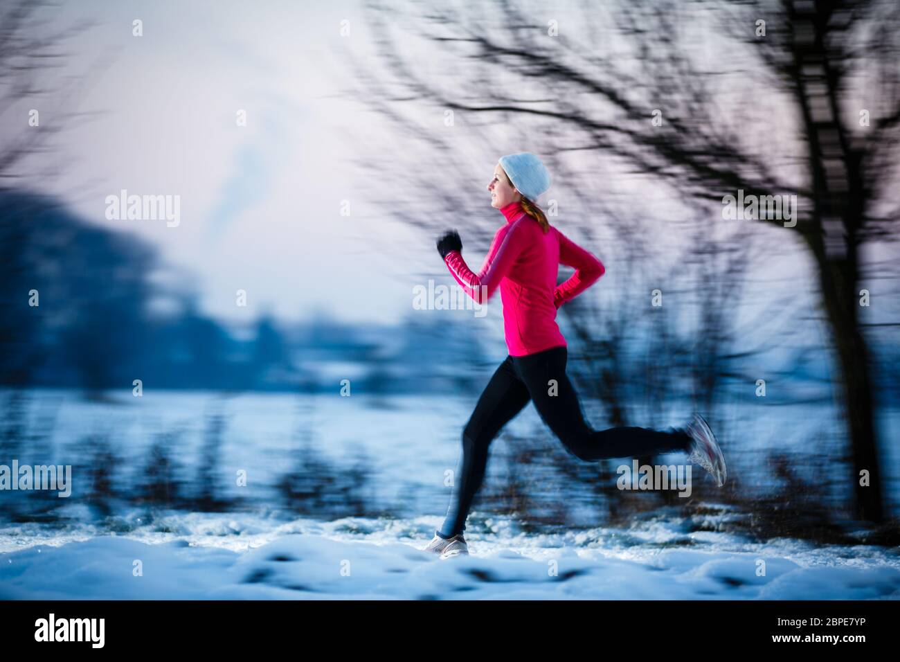 Winter running - Young woman running outdoors on a cold winter day ...