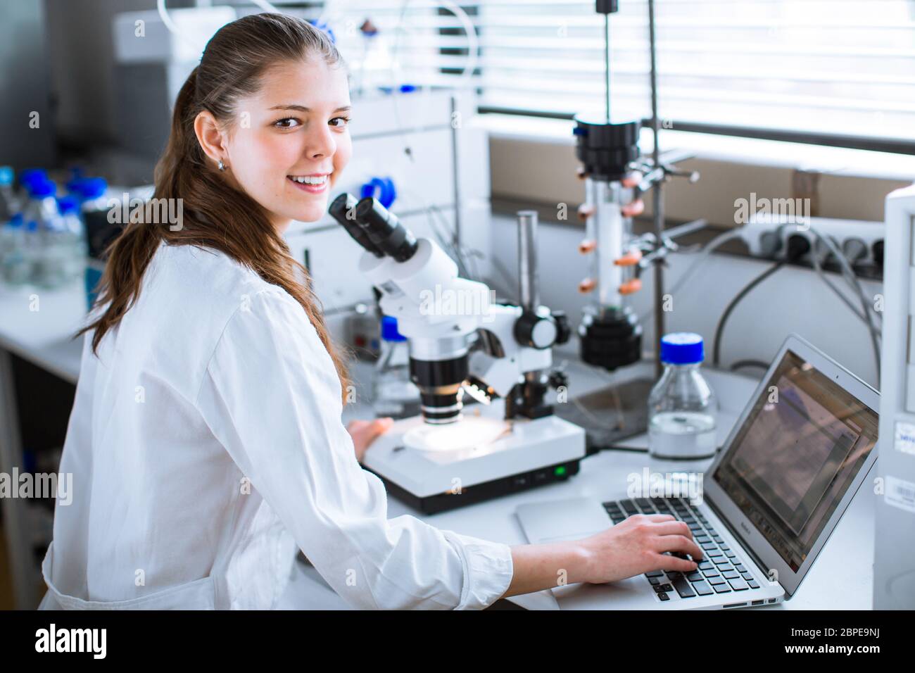 Portrait of a female chemistry student carrying out research in a ...