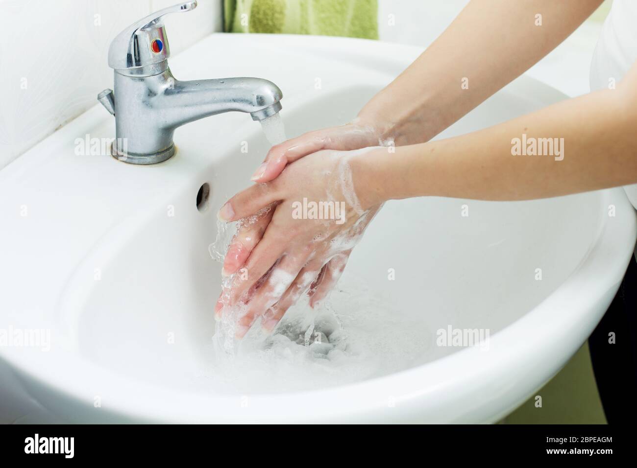 Washing Hands with streaming water in bathroom. Hygiene Stock Photo - Alamy