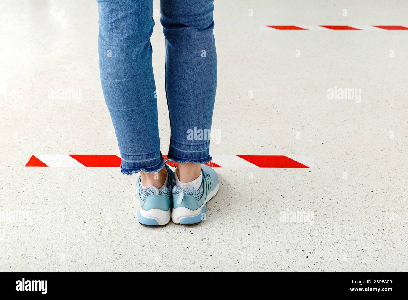 People stand in line keeping social distance, Woman standing behind a ...