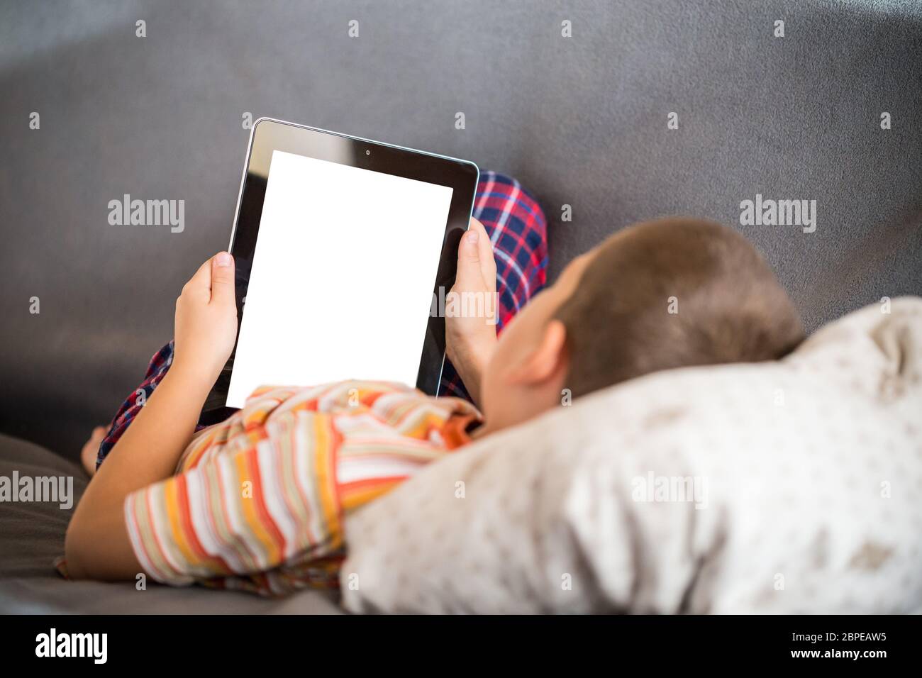 Little boy using a digital tablet in bed Stock Photo - Alamy