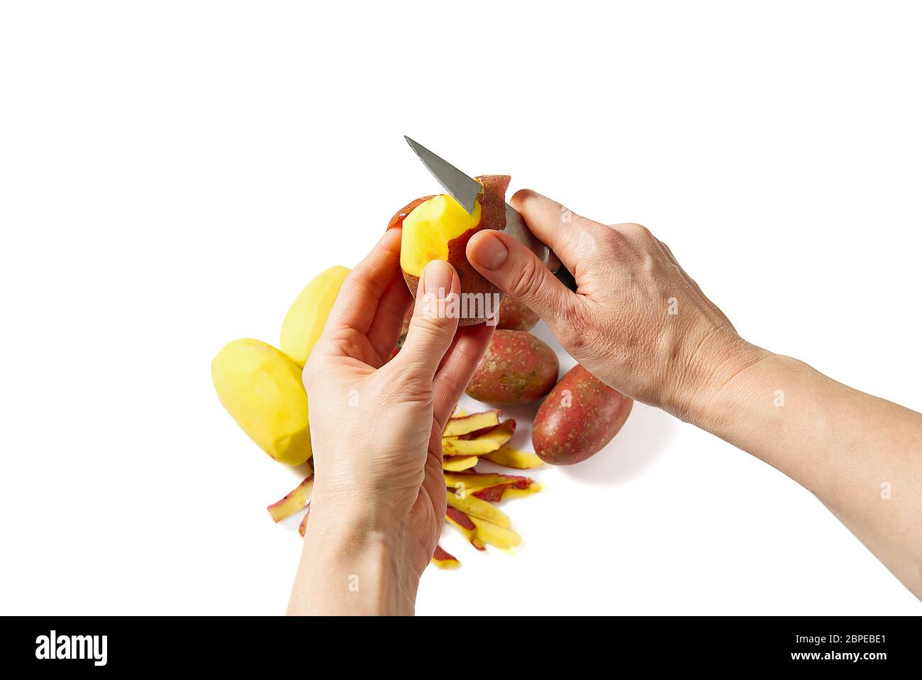 a pile of unpeeled potatoes and black potatoes peeling, white ...
