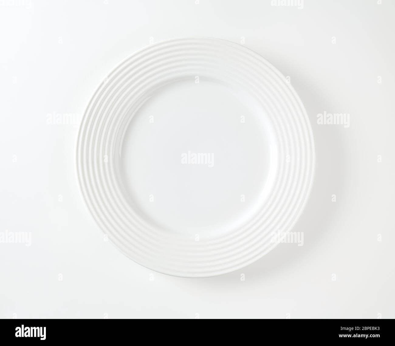White porcelain plate with embossed rings on the rim Stock Photo - Alamy