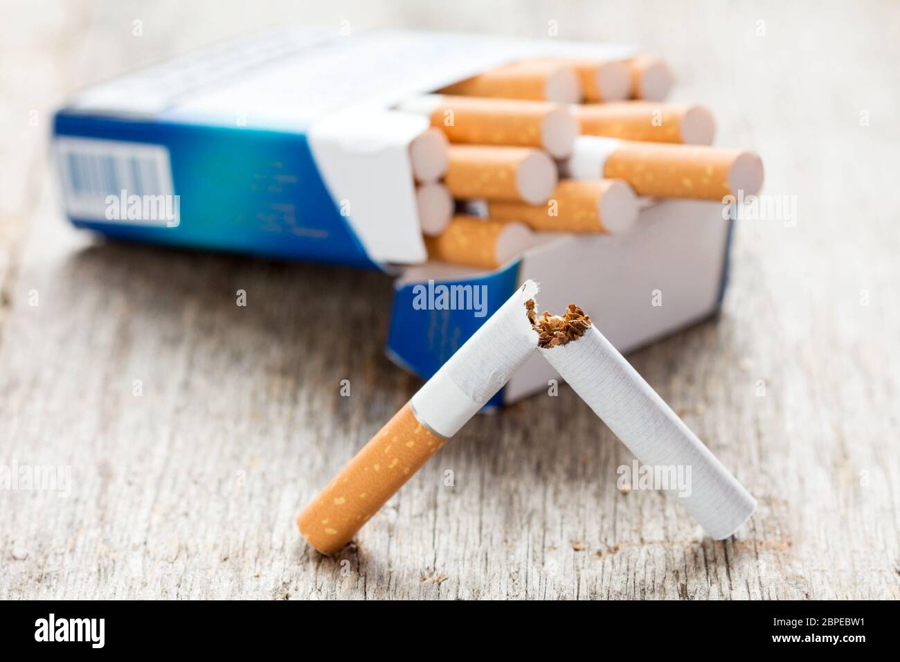 Broken cigarette in a front of full package Stock Photo - Alamy