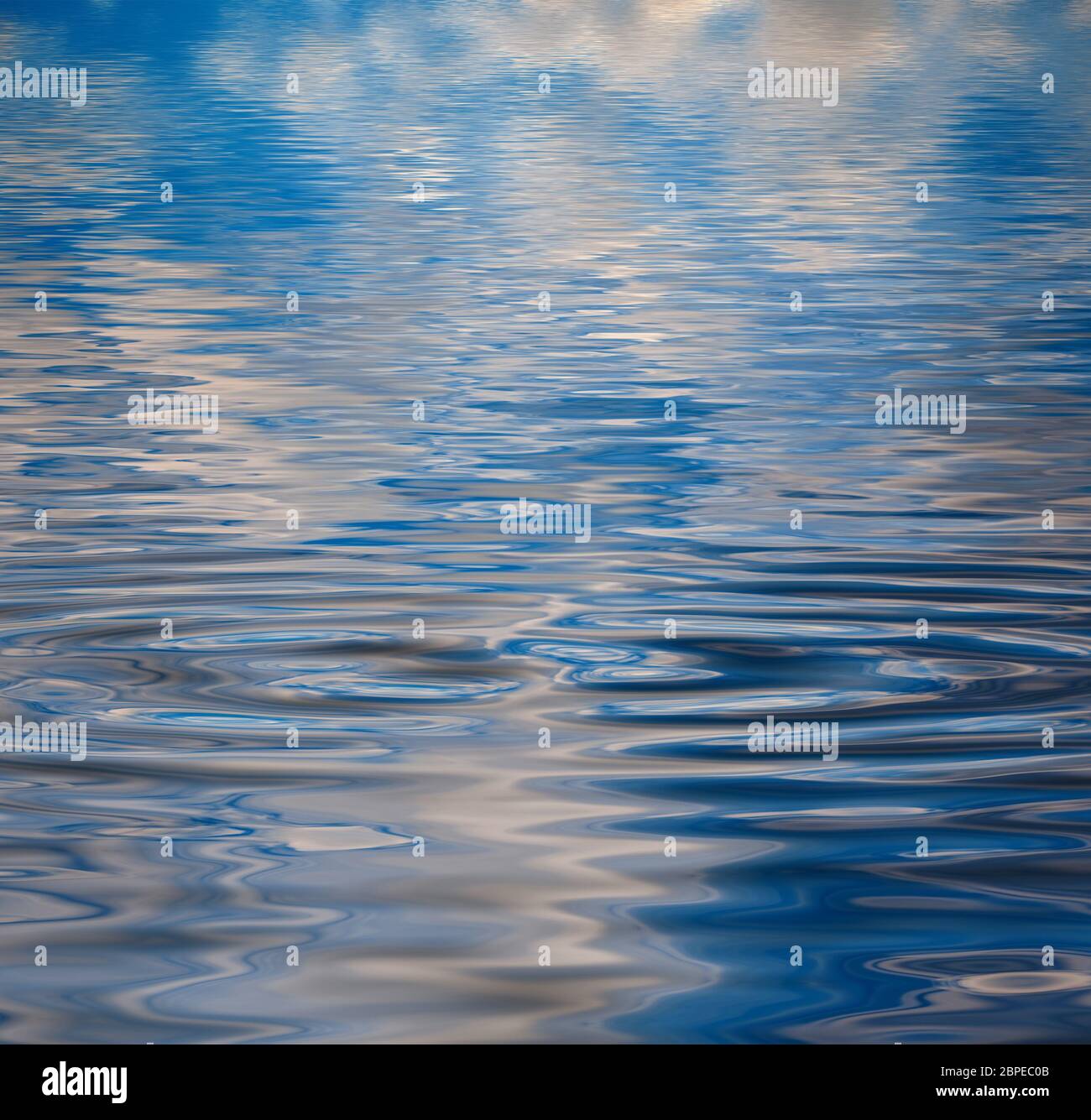 Beauty Surface Rippled of water with reflection clouds and sky ...