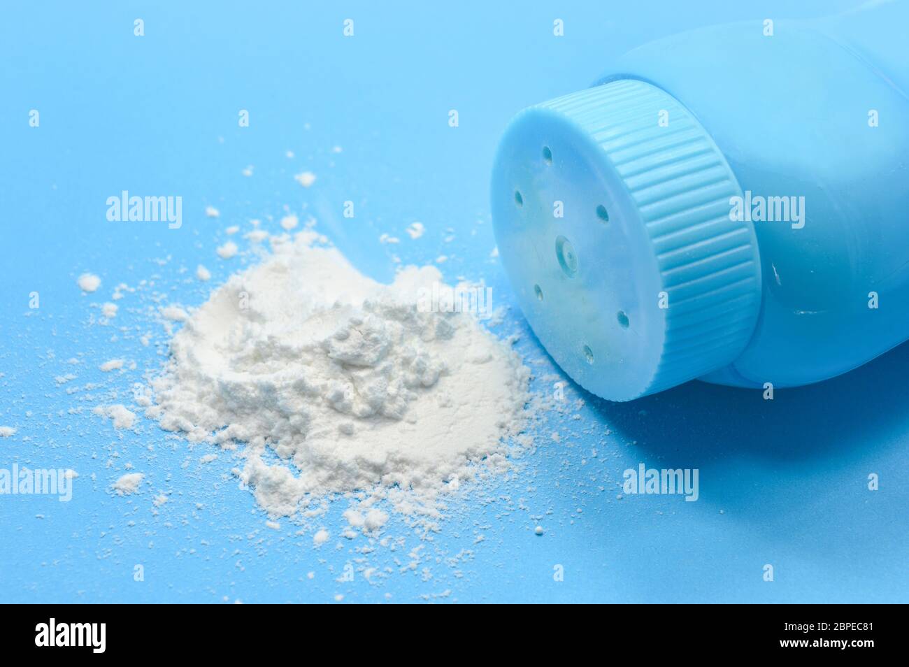 Baby talcum powder container on blue background Stock Photo - Alamy