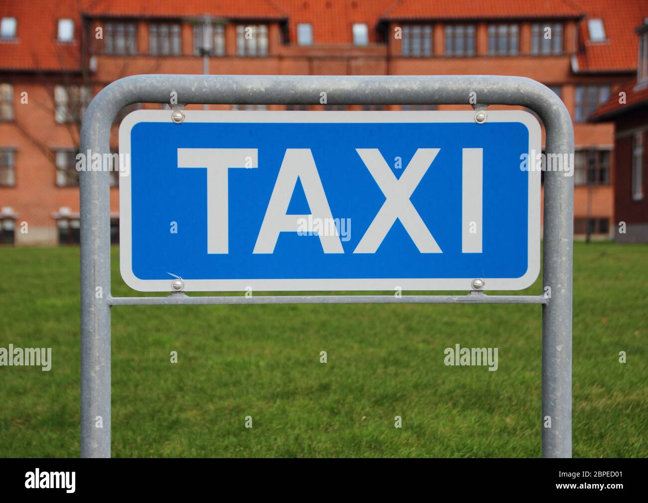 Metal Taxi Sign Isolated Closeup with Building and Grass Background ...
