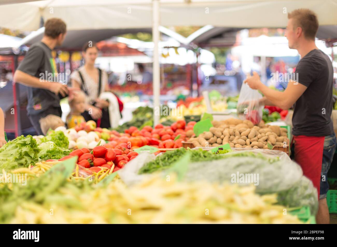 Farmers' food market stall with variety of organic vegetable. Vendor ...