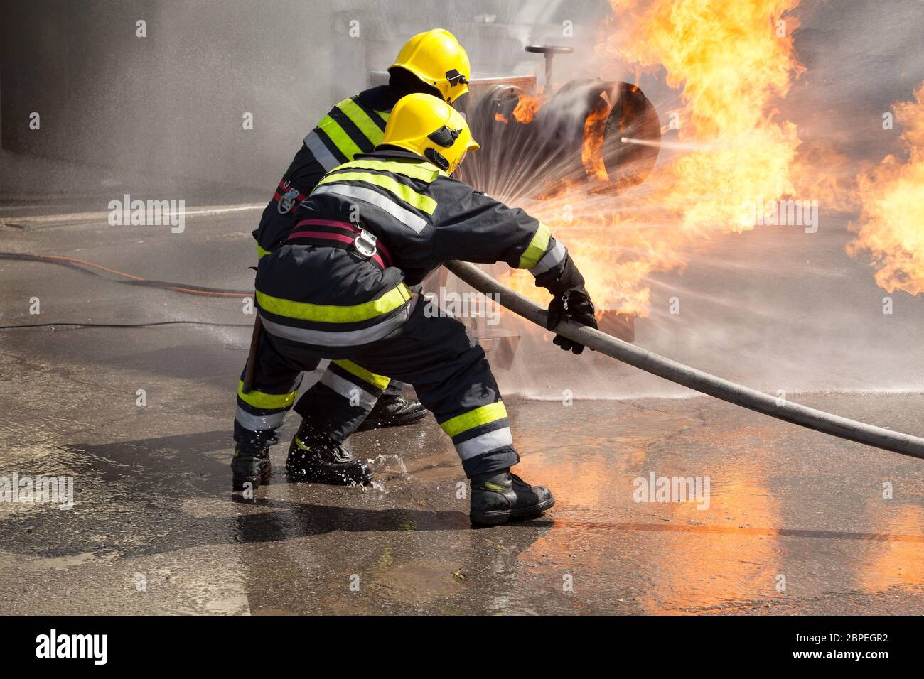 Firefighters attack a propane fire during a training exercise Stock ...