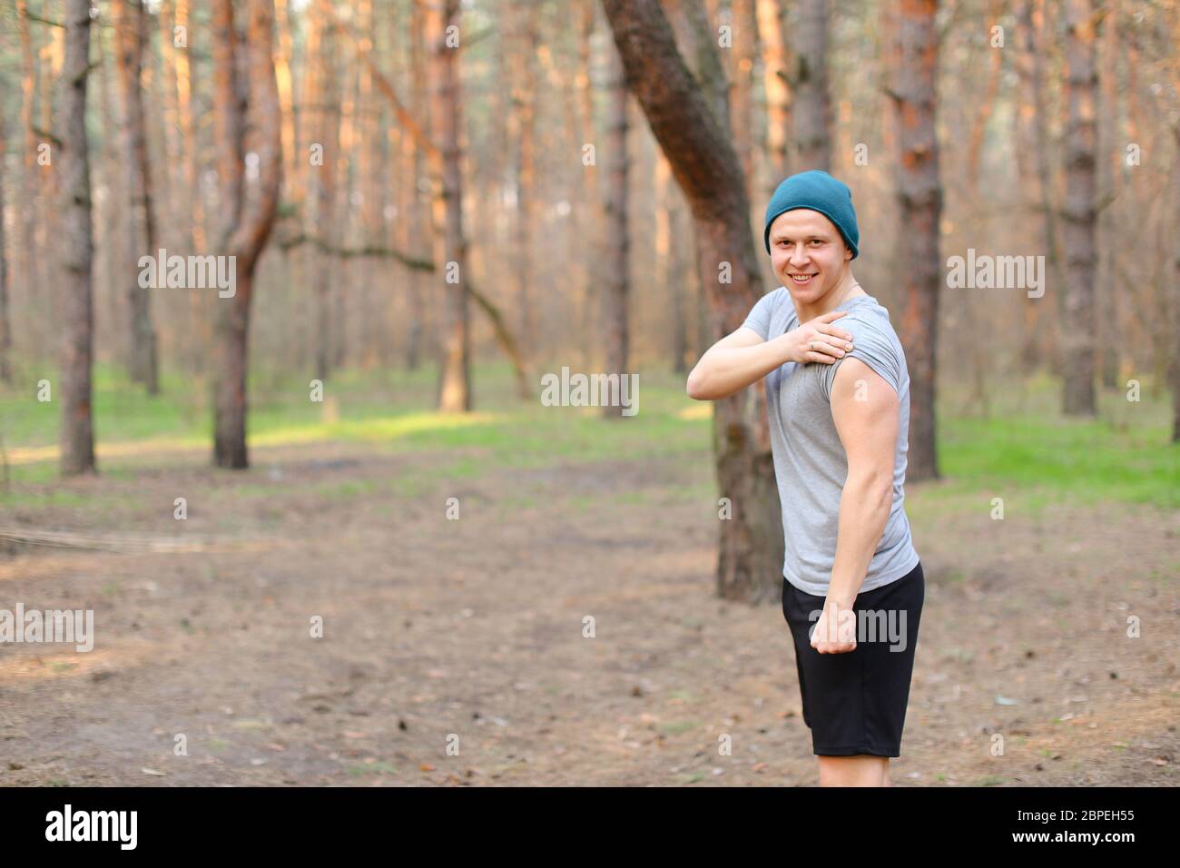 Young boy doing workout in morning park and showing biceps Stock Photo ...