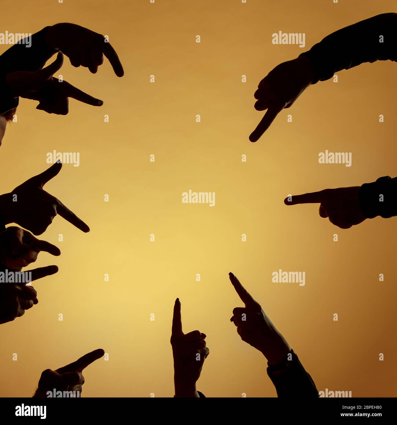 Many silhouettes of hands pointing ahead or out or inside on orange ...