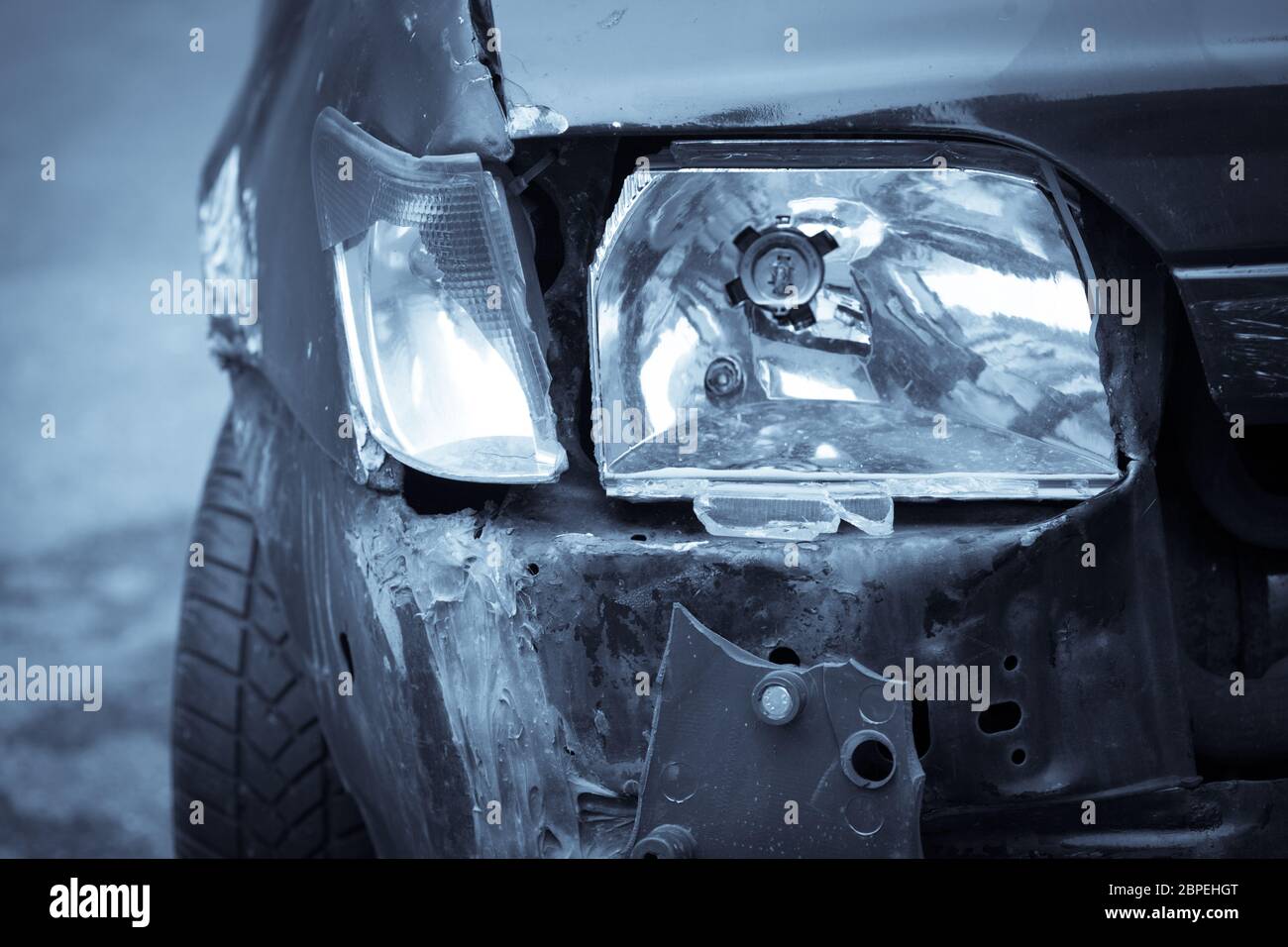 Color image of a crashed car with broken headlight Stock Photo - Alamy