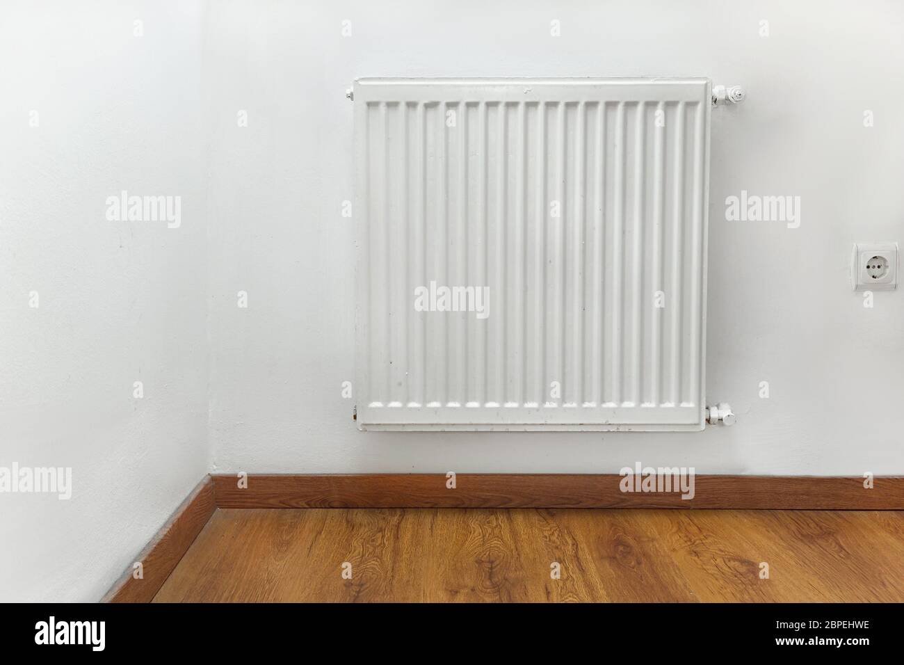 Heating radiator detail against white wall Stock Photo - Alamy