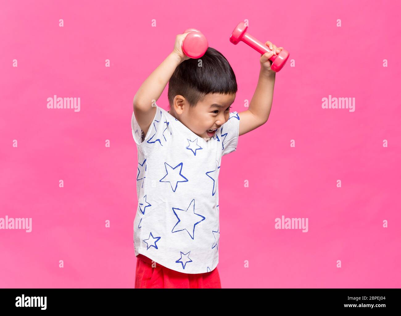 Little boy lifting up dumbbell Stock Photo - Alamy
