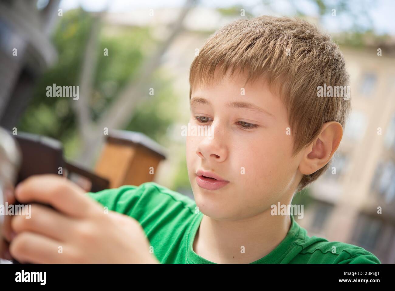10 - 12 year boy playing with smartphone Stock Photo - Alamy