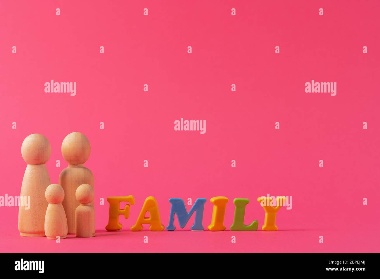 Wooden little figures of people. Family concept Stock Photo - Alamy