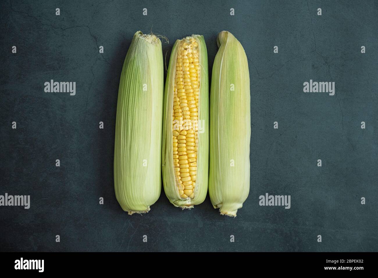 Fresh raw corn cobs on concrete, stone background. Tasty, healthy and ...