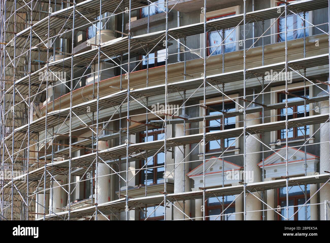scaffolding at the facade of a building under construction, multi ...