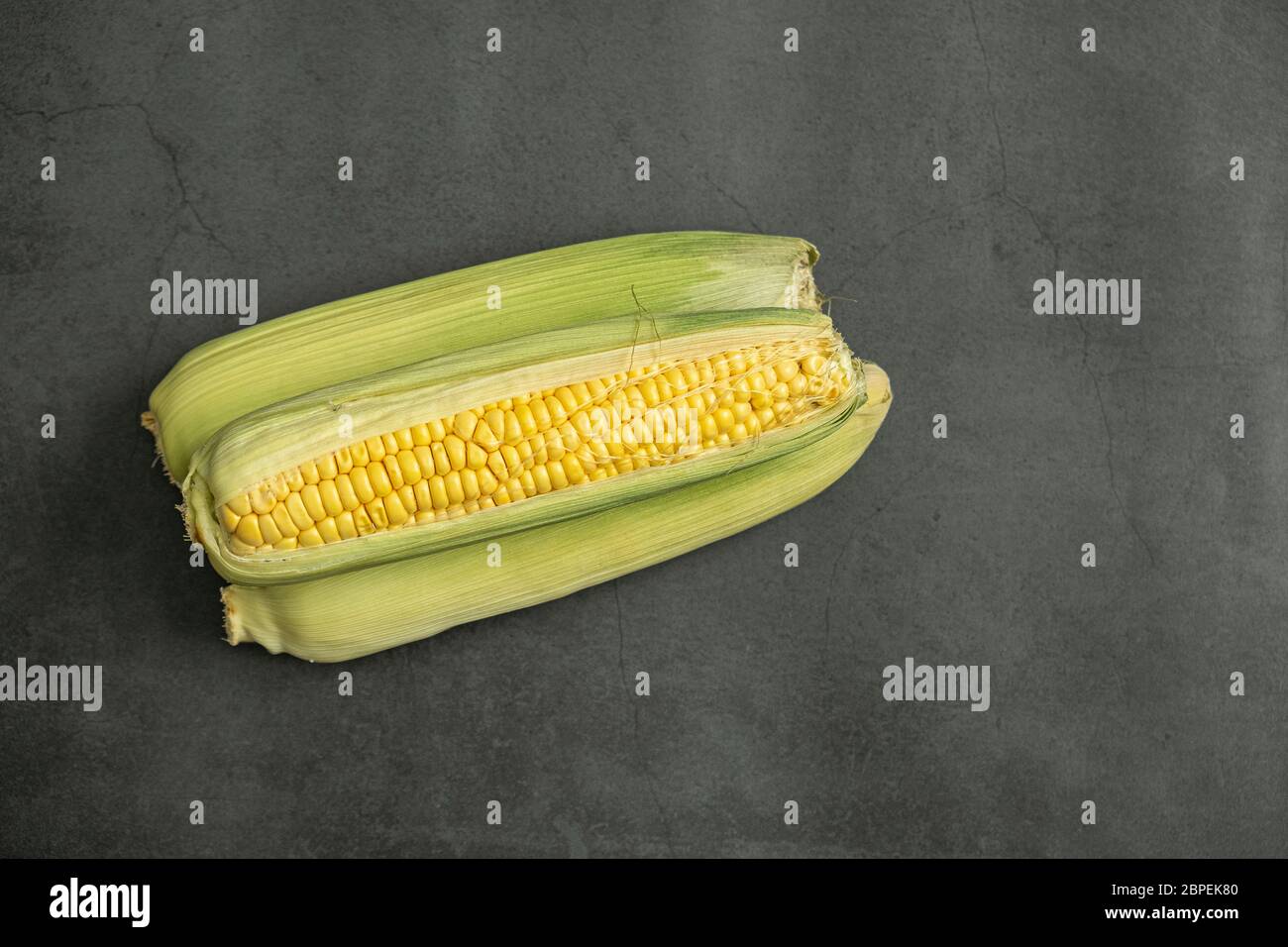 Fresh raw corn cobs on concrete, stone background. Tasty, healthy and ...